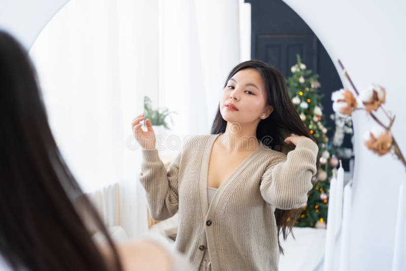 Young Beautiful Asian Woman Looking at Her Reflection in the Mirror and ...