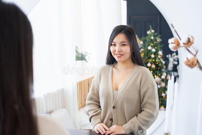 Young Beautiful Asian Woman Looking at Her Reflection in the Mirror and ...