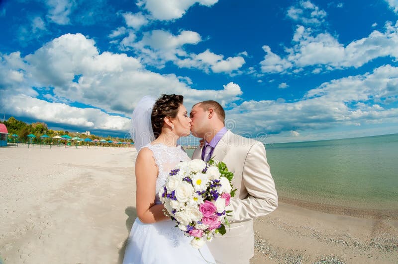 Young and Beautiful Bride and Groom on the Beach Stock Photo - Image of ...
