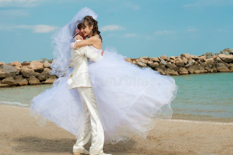 Young and Beautiful Bride and Groom on the Beach Stock Photo - Image of ...