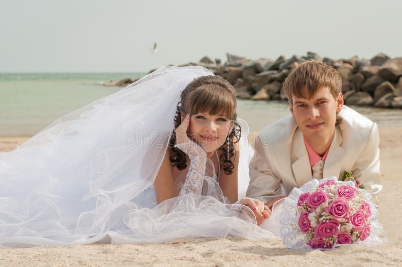 Young and Beautiful Bride and Groom on the Beach Stock Image - Image of ...