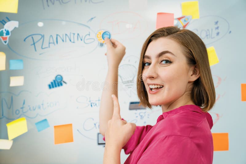 Businesswoman Puts Sticker on Glass Board while Finding a Solution ...