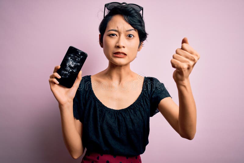Young Beautiful Chinese Woman Holding Broken Smartphone Showing Craked
