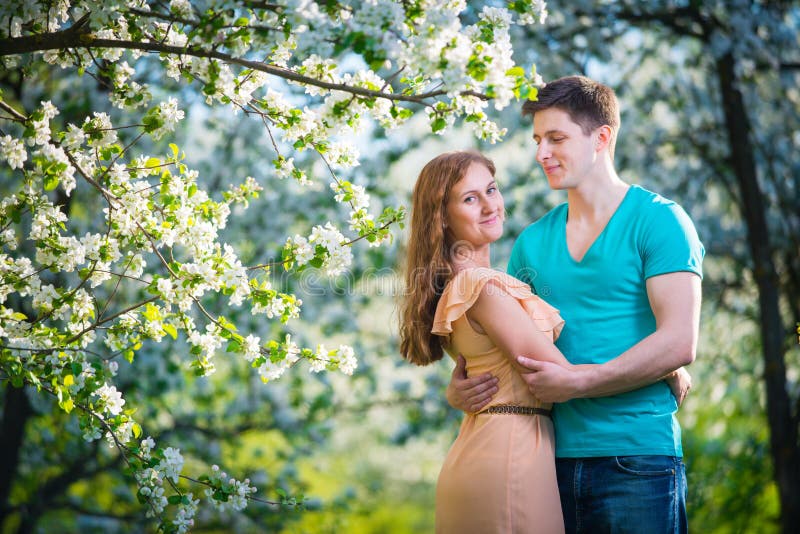 Young Beautiful Couple in Love among Apple Trees Stock Image - Image of ...