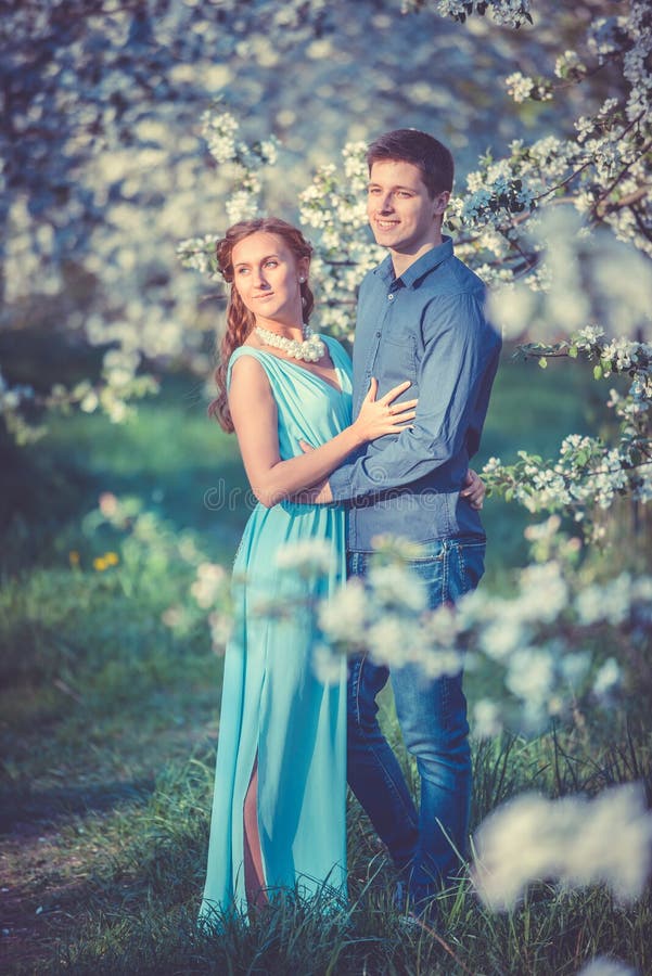 Young Beautiful Couple in Love among Apple Trees Stock Image - Image of ...