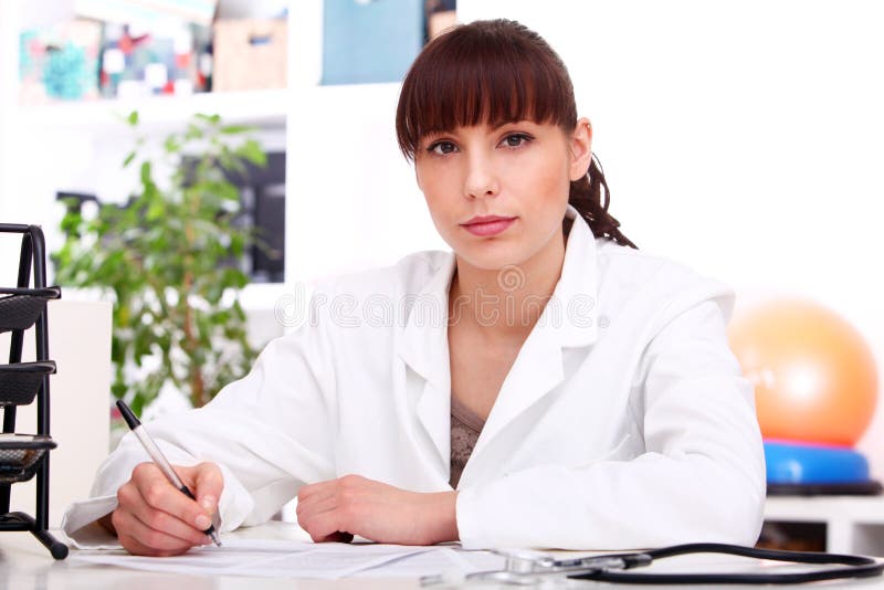 Young Beautiful Doctor at Table Stock Image - Image of looking ...