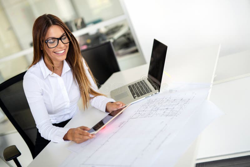 Young Female Architect Working with Computer and Blueprints Stock Photo ... Young Female Architect Working with Computer and Blueprints Stock Photo ...