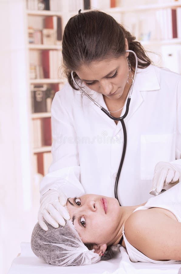 Young Beautiful Female Doctor Checking Patient Stock Photo - Image of ...