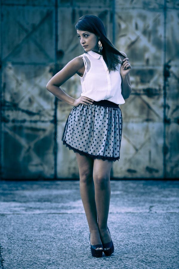 Young Beautiful Female Model Standing in Front of the Old Rusty Stock ...