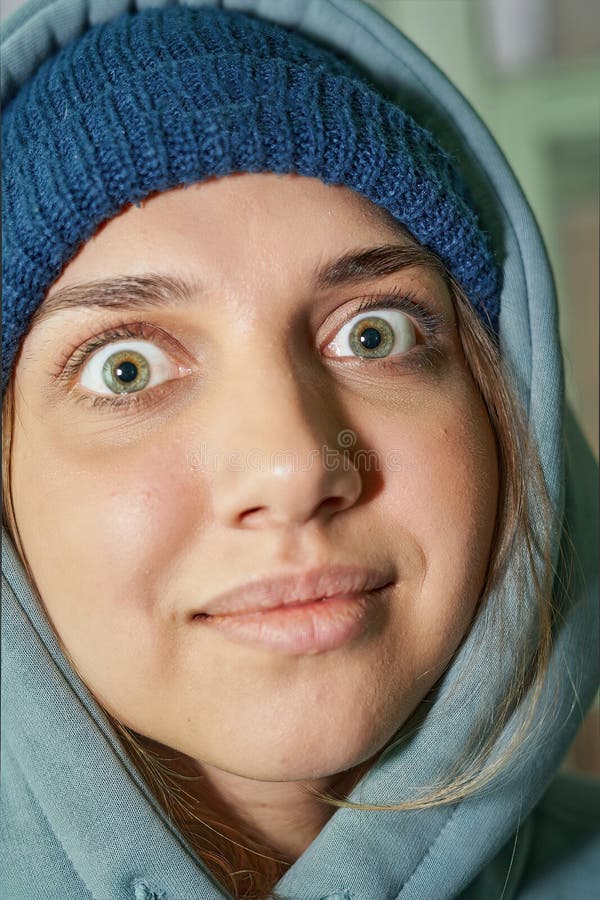 Young Beautiful Girl With Big Eyes Looking At Camera In A Sweatshirt