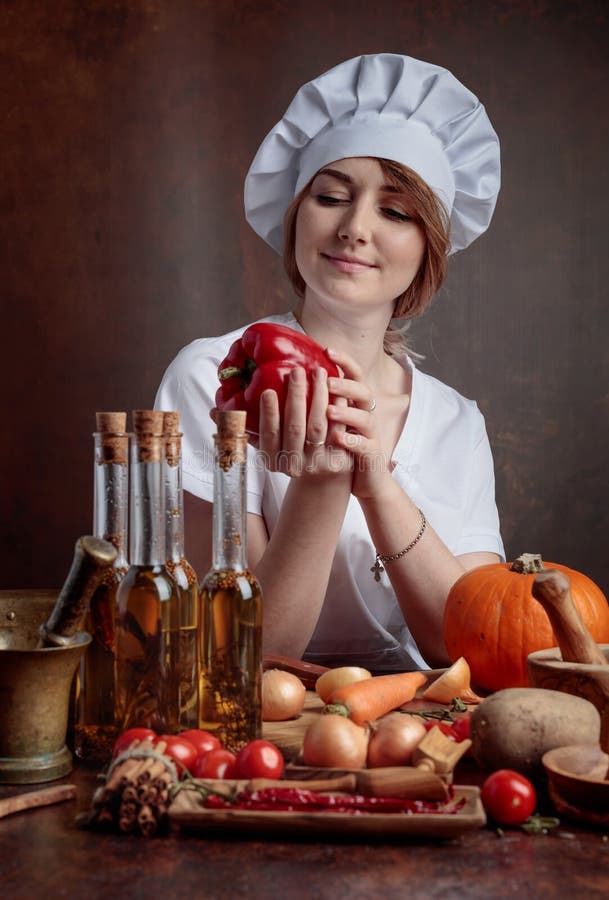 Young Beautiful Girl in a Chef Uniform with Red Paprika . Stock Photo ...