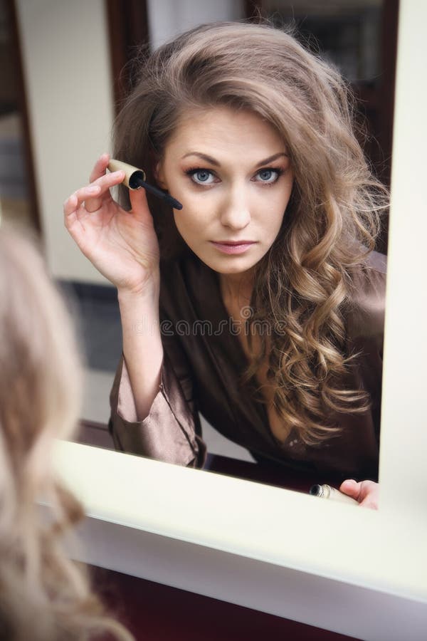 The Young Beautiful Girl Does Makeup Stock Photo - Image of fashion ...