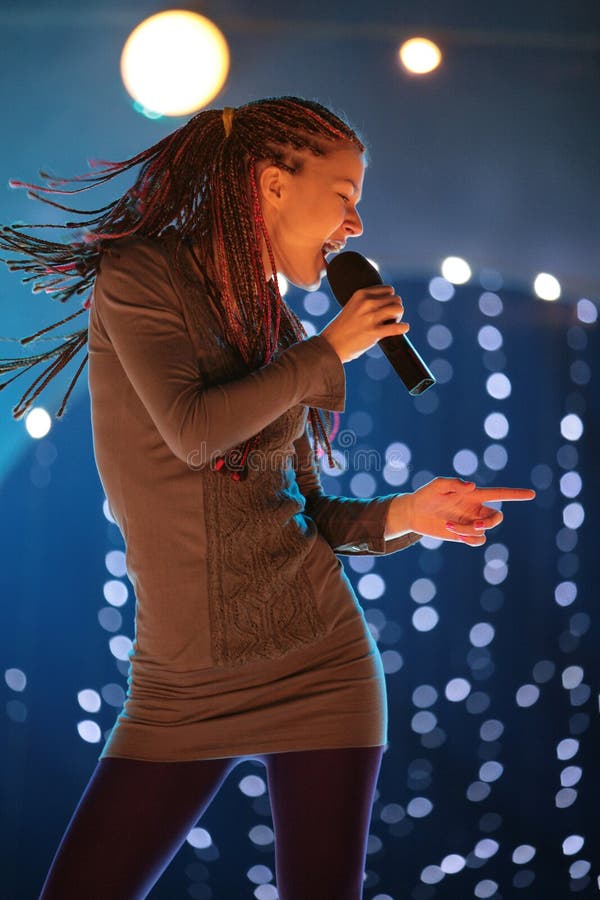 Young Beautiful Girl with a Microphone in Hand Stock Image - Image of ...