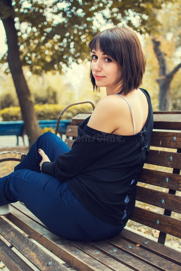 Young Beautiful Girl Sitting on a Bench Stock Image - Image of young ...