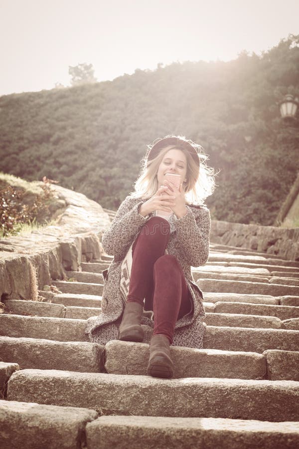 Young Beautiful Girl Sitting on the Stairs in the Park. Stock Image ...
