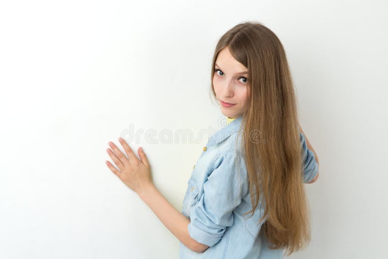 Young Beautiful Girl Stands in Front of the White Wall Stock Image ...