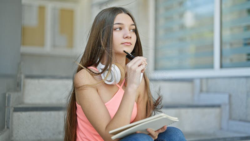 Young Beautiful Girl Student Taking Notes Sitting on Stairs Thinking at ...