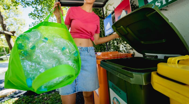 A Young Beautiful Girl Throws Sorted Garbage into Special Bins Stock ...