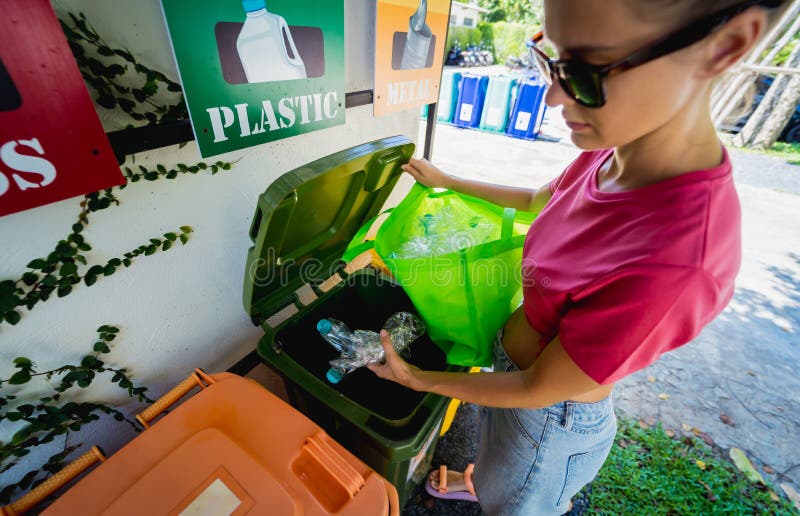 A Young Beautiful Girl Throws Sorted Garbage into Special Bins Stock ...