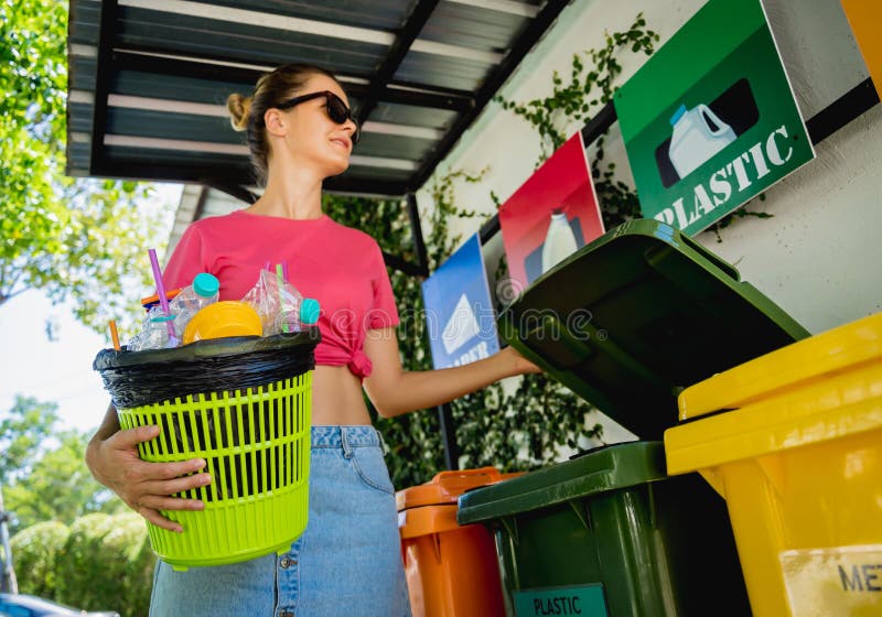 A Young Beautiful Girl Throws Sorted Garbage into Special Bins Stock ...