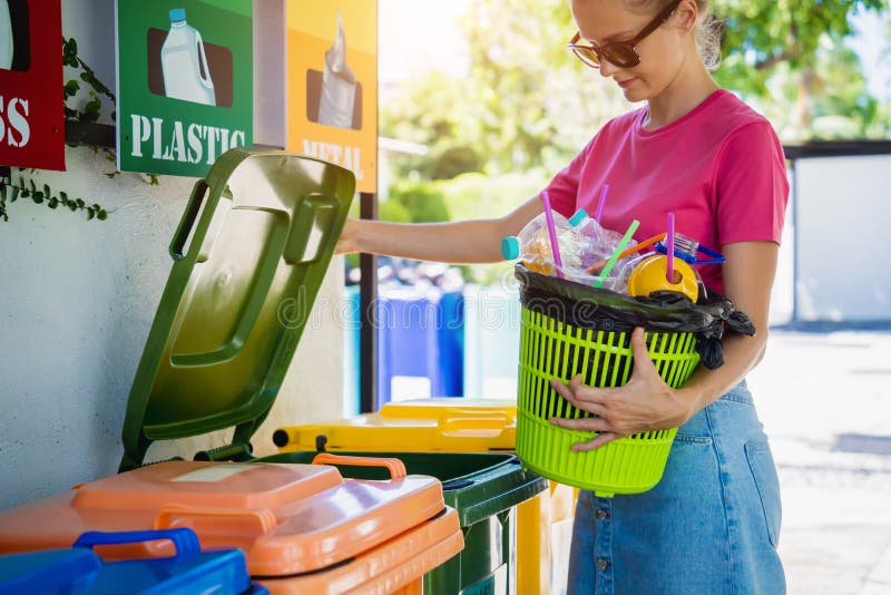 A Young Beautiful Girl Throws Sorted Garbage into Special Bins Stock ...