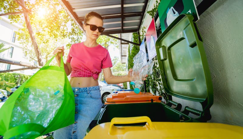 A Young Beautiful Girl Throws Sorted Garbage into Special Bins Stock ...
