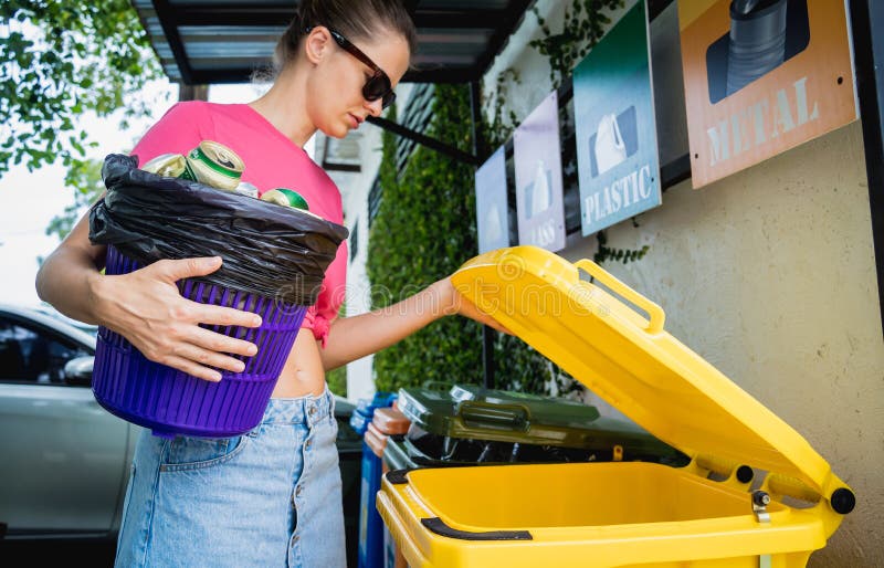 A Young Beautiful Girl Throws Sorted Garbage into Special Bins Stock ...