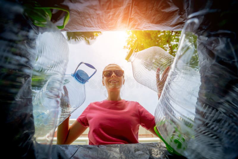 A Young Beautiful Girl Throws Sorted Garbage into Special Bins Stock ...