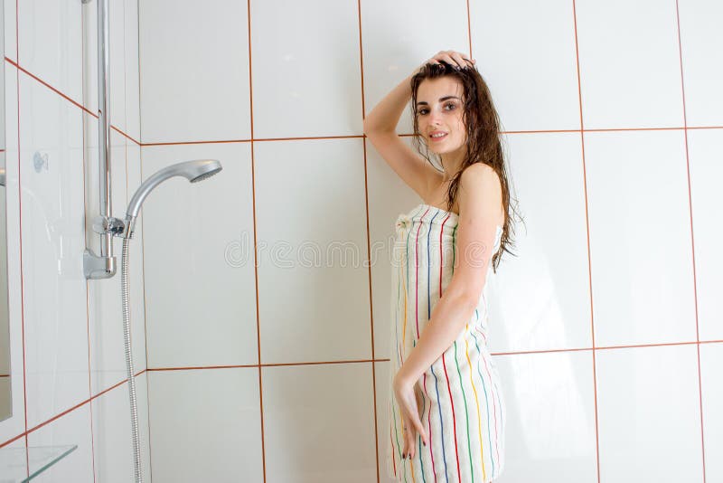 Young Beautiful Girl In A Towel On The Body Keeps Your Hand Wet Hair
