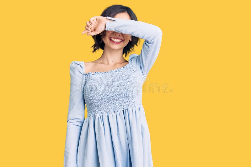 Young Beautiful Girl Wearing Casual Clothes Covering Eyes With Arm