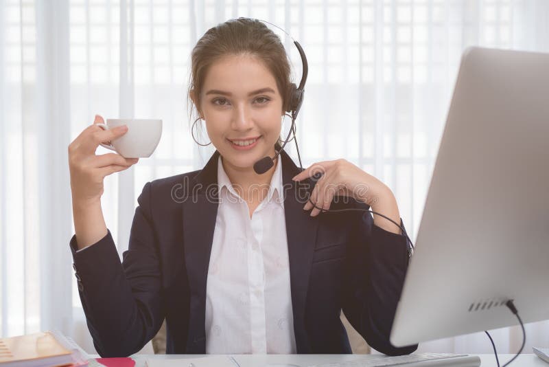 Young Beautiful Girl Working at a Laptop in a Small Medium Enterprise ...
