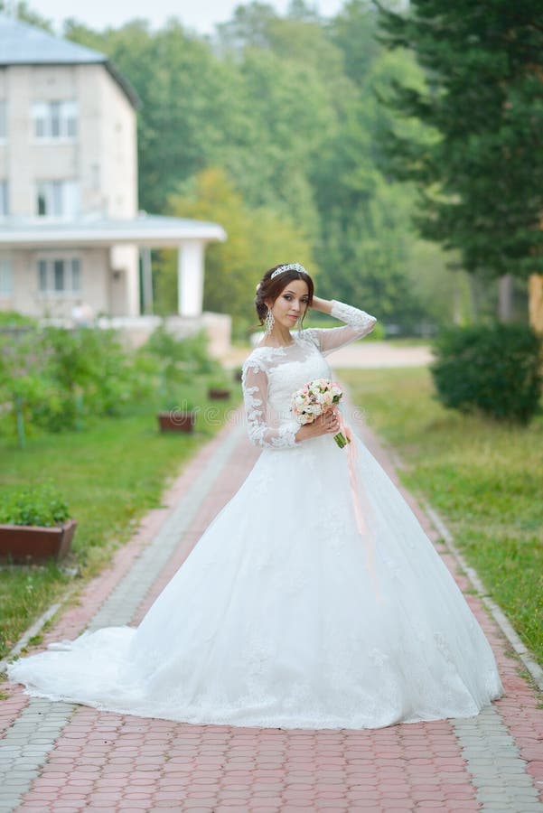 Young Beautiful Happy Bride with Flower Bouquet in Park Stock Photo ...