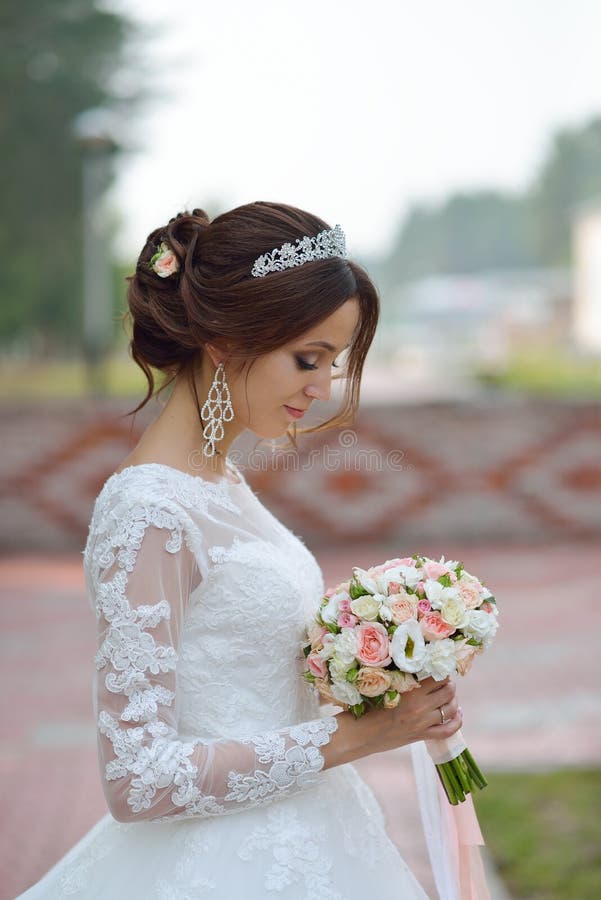 Young Beautiful Happy Bride with Flower Bouquet in Park Stock Image ...