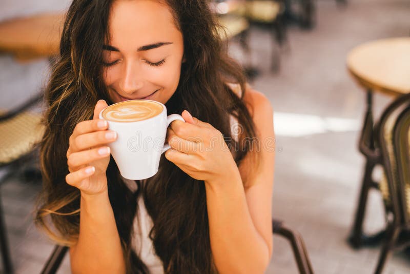 Young Beautiful Happy Woman Enjoying Cappuccino in a Cafe Stock Image ... Young Beautiful Happy Woman Enjoying Cappuccino in a Cafe Stock Image ...
