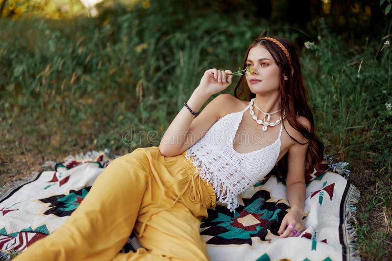 Young Beautiful Hippie Woman Lying On The Ground In Nature In The Fall