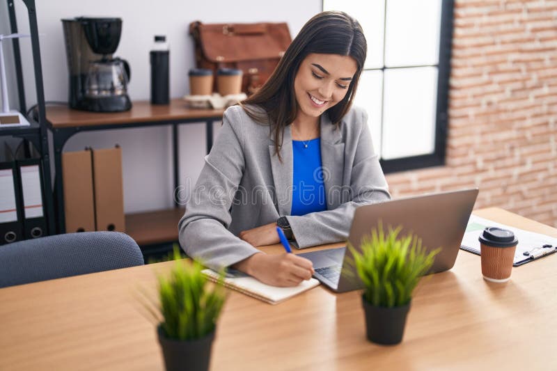 Young Beautiful Hispanic Woman Business Worker Using Laptop Writing on ...