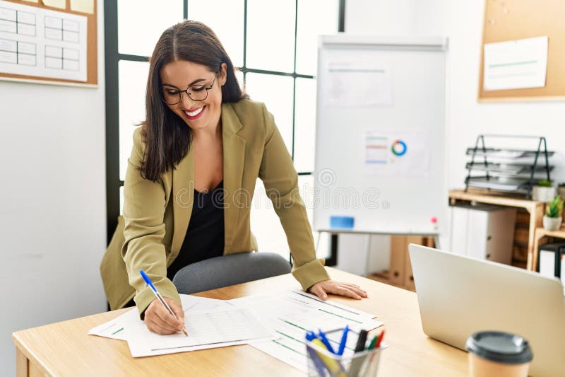 Young Beautiful Hispanic Woman Business Worker Writing on Document ...