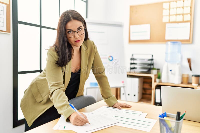 Young Beautiful Hispanic Woman Business Worker Writing on Document ...