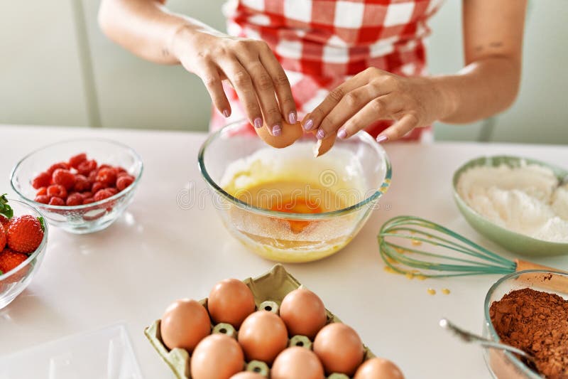 Young Beautiful Hispanic Woman Pouring Egg on Bowl at the Kitchen Stock ...