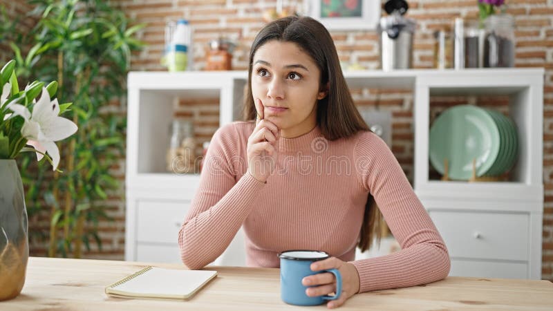 Young Beautiful Hispanic Woman Sitting on Table Thinking at Dinning ...