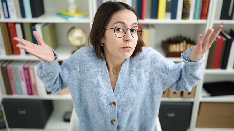 Young Beautiful Hispanic Woman Student Sitting on Table with I Dont ...