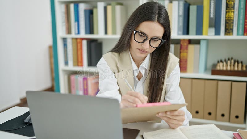 Young Beautiful Hispanic Woman Student Stressed Writing on Document at ...