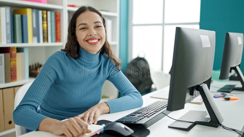 Young Beautiful Hispanic Woman Student Using Computer Taking Notes at ...