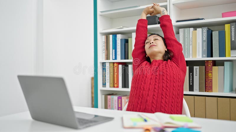 Young Beautiful Hispanic Woman Student Using Laptop with Back Ache ...