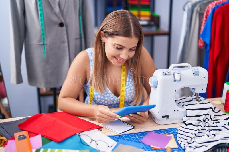 Young Beautiful Hispanic Woman Tailor Smiling Confident Using Touchpad ...