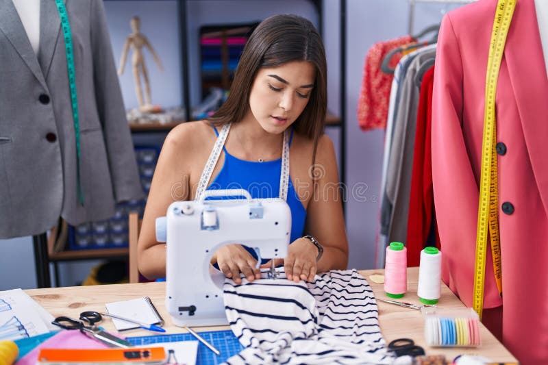 Young Beautiful Hispanic Woman Tailor Using Sewing Machine at Tailor ...