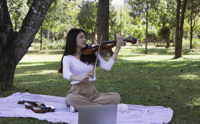 Young Beautiful Lady Playing Violin in a Park.relax Time Stock Image ...