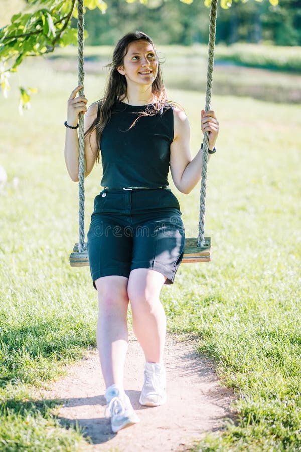 Young Beautiful Long-haired Girl on a Rope Swing. Stock Image - Image ...