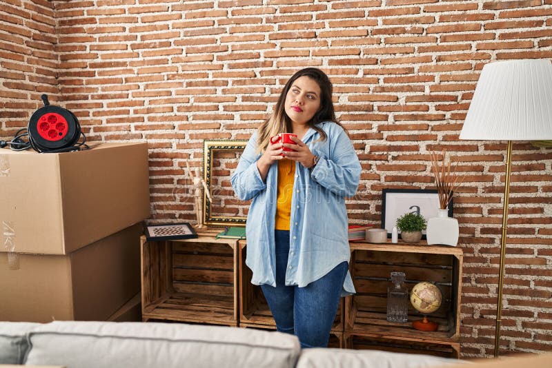 Young Beautiful Plus Size Woman Drinking Coffee with Relaxed Expression ...