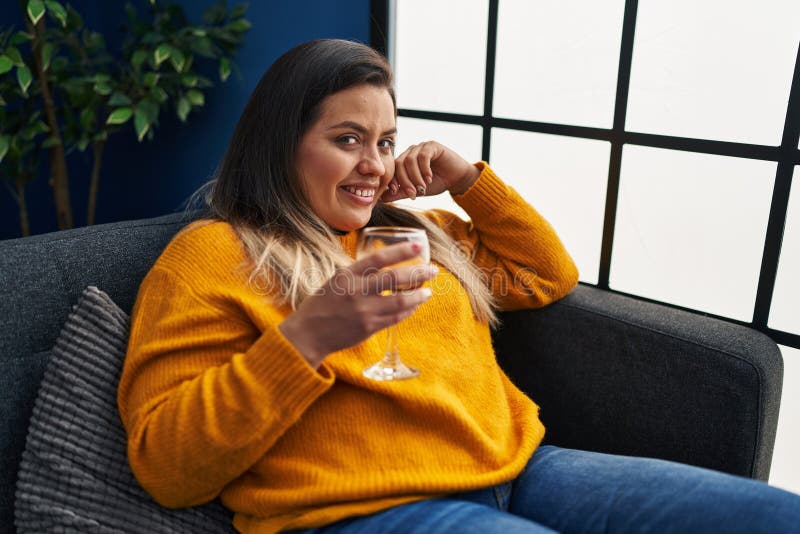 Young Beautiful Plus Size Woman Drinking Wine Sitting on Sofa at Home ...
